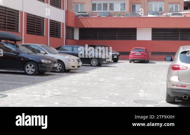 Dense parking in the courtyard of a high-rise building. Lots of cars in ...