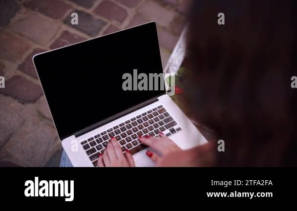 Womans hands work on the keyboard with mock up screen computer ...