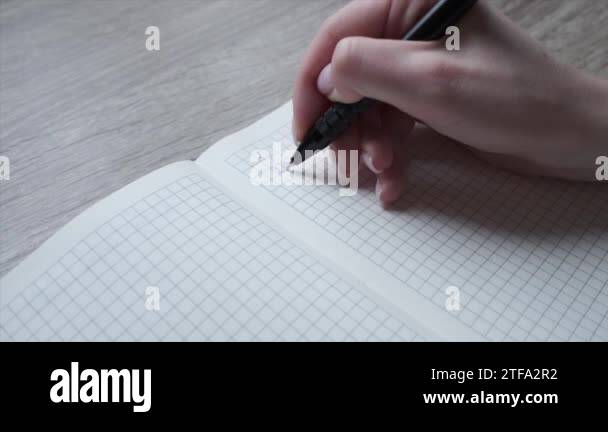 A woman writes numbers and numbering from 1 to 10 with a pen in a ...