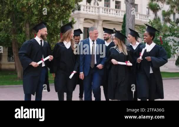 Multiethnic graduates students in the college park walking in group ...
