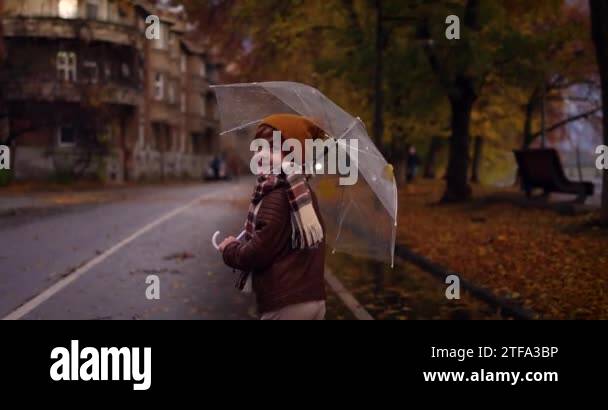 cute happy kid waving goodbye, walking away along the autumn street in ...