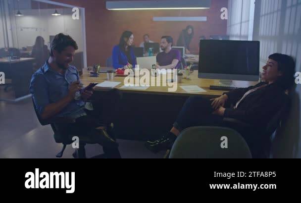 People working at Office workplace interior at night. Interior of busy ...