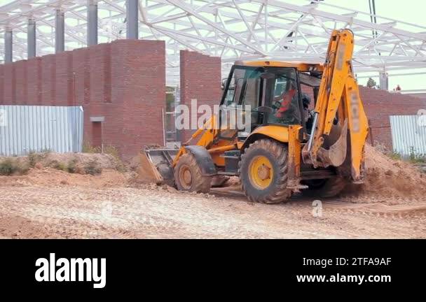 The tractor works at a construction site. Working process at a ...
