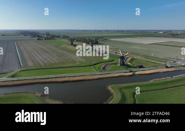 Historic dutch windmills in a farm and grass field landscape in The ...