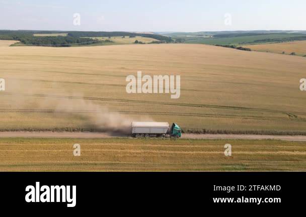Aerial view of lorry cargo truck driving on dirt road between ...