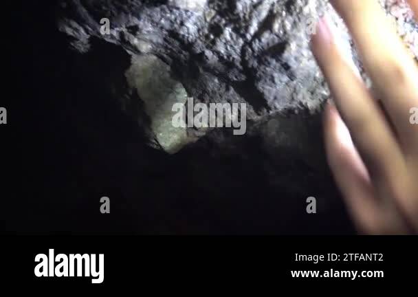 A drop on an old rusty screw in a cave. Wet walls. Macro photography of ...