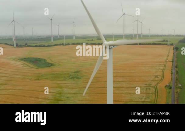Elevated footage of spinning rotor of wind turbine. Wind park producing ...