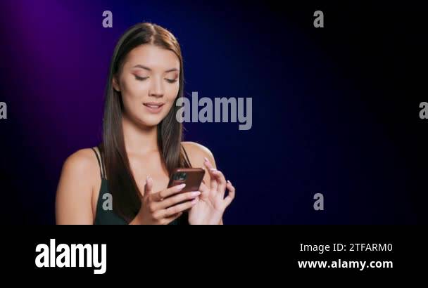 Smiling pensive young woman 20s in black dress posing isolated on black ...