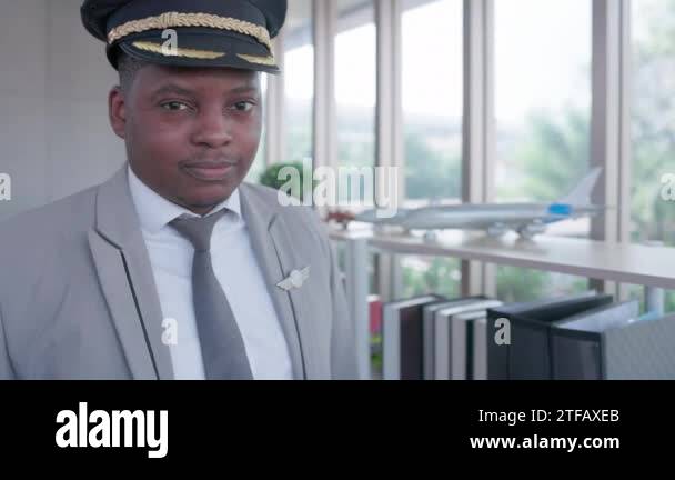 A young black African pilot smiles in the office Stock Video Footage ...