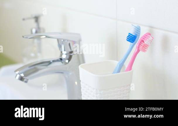 Woman changing old brushes for new modern ultrasonic toothbrush in ...