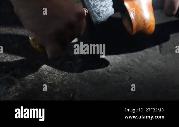 keris craft. A man takes a kris out of its container. Javanese ...