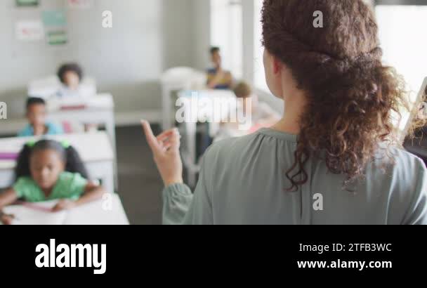 Video of back view of caucasian female teacher conducting lesson in ...