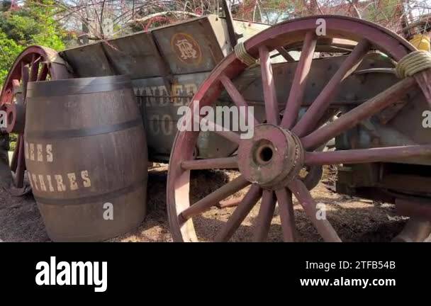 A cart with a wheel and a barrel stands near the attraction of the ...