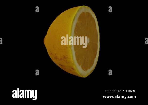 Realistic render of a spinning half Lemon on black background. The ...