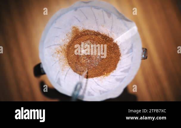 drip coffee brewing. close-up. barista pours boiling water from a ...