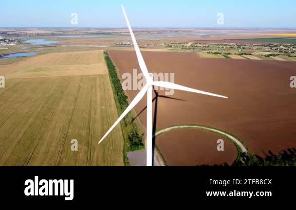 Wind turbine built in field generates renewable energy at rural station ...