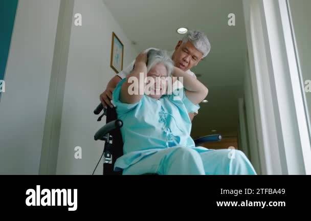 elderly woman with psychiatric symptoms is in a wheelchair with an elderly couple caring for her ...