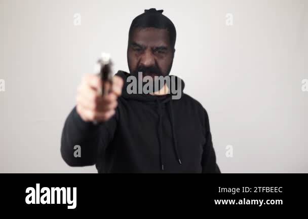 Bandit with the sock on head holding gun, menacing, furious and angry ...