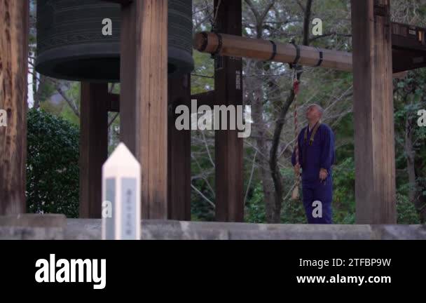 Tokyo, Japan-03 February, 2020: The Buddhist priest monk hits ringing ...