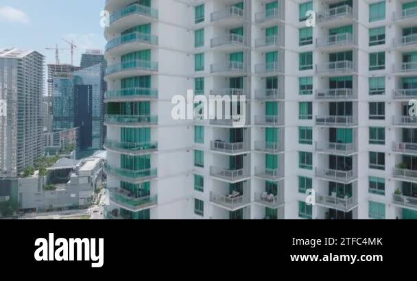 Rising shot of apartment building facade with windows and balconies ...