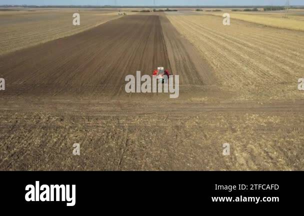 Above dolly move, flying over in backwards, tractor is pulling seed ...