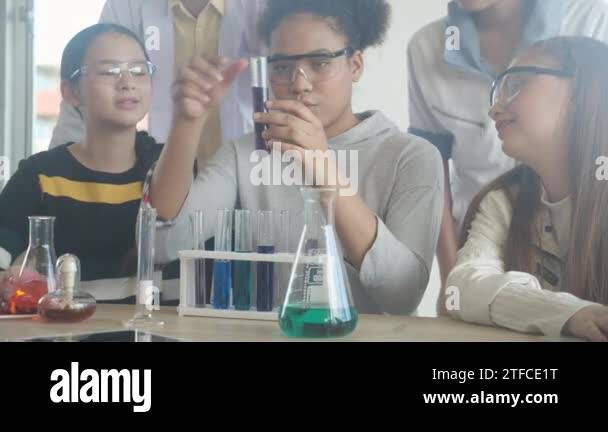 Young teacher teaching group student about science and explaining ...
