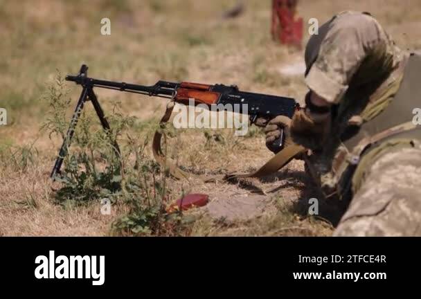 Unloading machine gun, soldier lying with gun, Army war concept, ready ...
