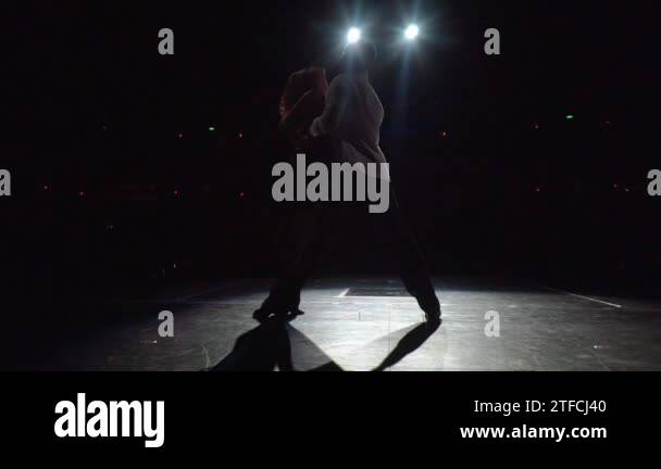 Man passionately hugs woman bent backwards,tango steps spinning around ...