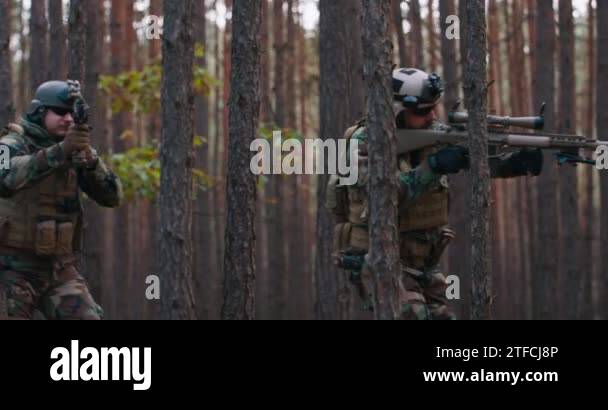 Squad of soldiers during military operation fully equipped camouflage ...