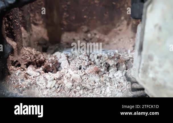 Sweeping burnt ash into the pan with a broom in the boiler. Frill in a ...