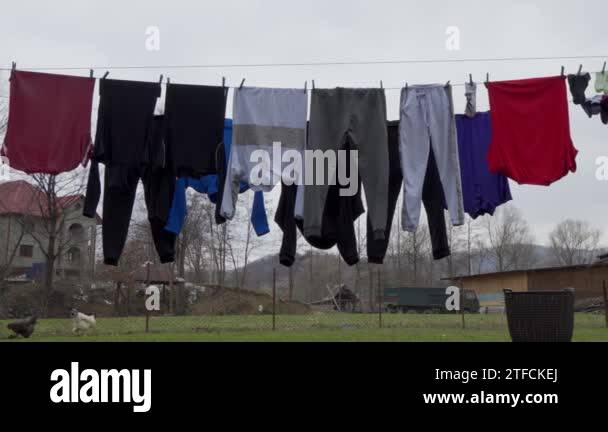 Clothes after washing, drying on a line, in the backyard of the house ...