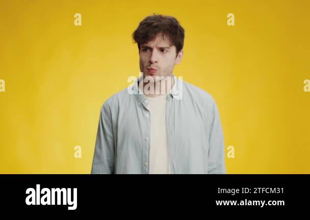 Young guy thinking about problem solution, comparing variants and ...