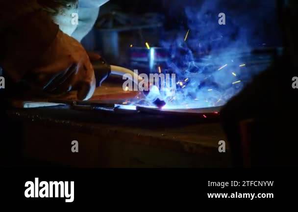 close-up, A man welds plates for body armor from springs. homemade ...