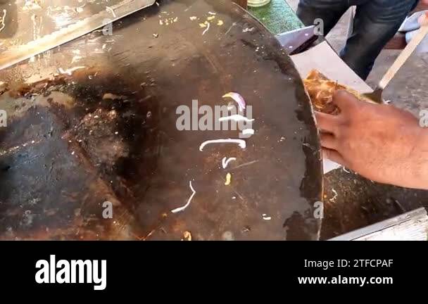 Wrapping naan tikki roll in paper, Spicy wrap pakistani and indian ...