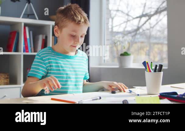 Boy is Doing his Homework at the Table. Cute Child is Learning at Home ...
