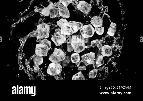 Super slow motion of rotating ice cubes with splashing water, top view ...