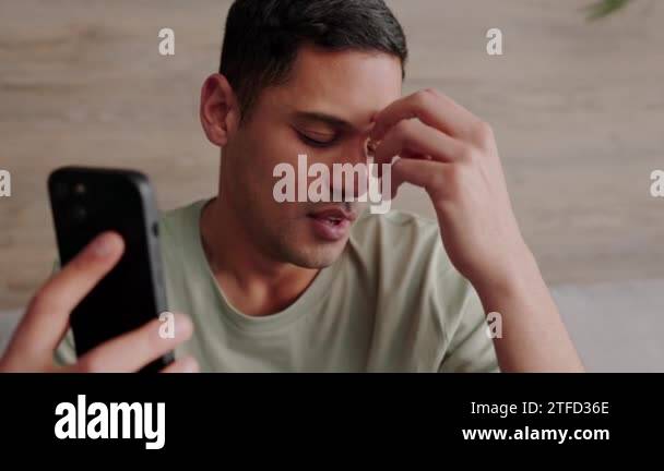 Headache, stress and phone with a frustrated man talking on a call and ...