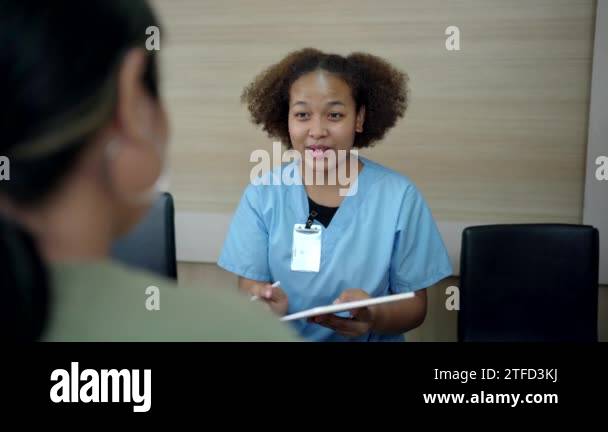 People making an appointment with medical staffs at reception desk in ...
