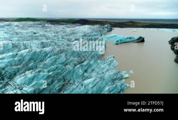 Thick layer of frozen ice in glacial lake of solheimajokull, Iceland ...