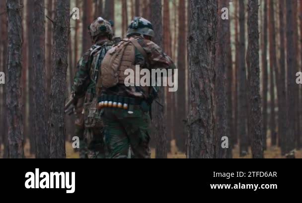 Squad of soldiers during military operation fully equipped camouflage ...