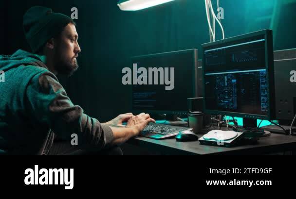 Male hacker using keyboard to type a dangerous malware into bank system Hacker Breaks into Stock ...