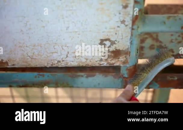 Man using metal brush for old paint and rust removing. Process of ...