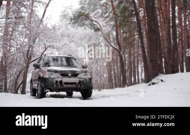 Winter driving. Off-road riding on winter forest snowy road. One suv ...