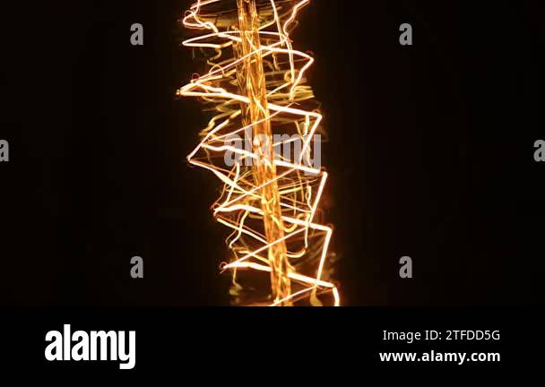 The incandescent Edison bulb lamp with a tungsten filament brighten and ...