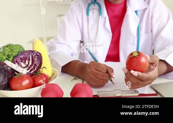 Professional nutrition doctor African-American female nutritionist sits ...