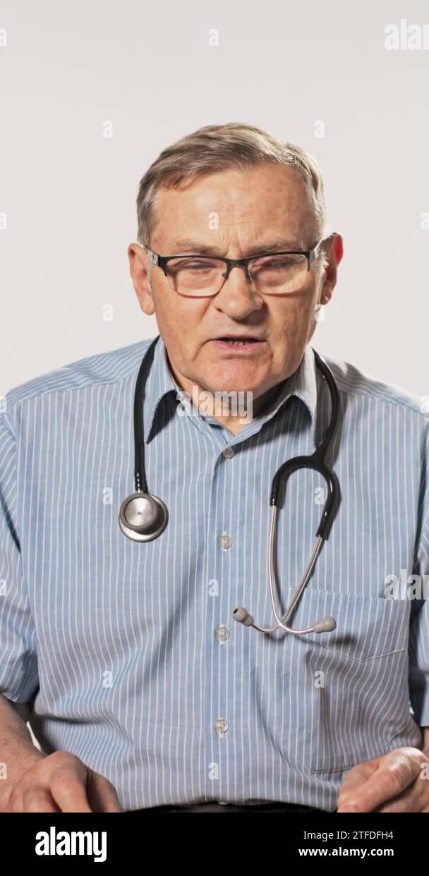 Conversation, interview with calm, mature, elderly doctor with glasses ...