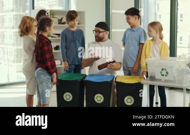Male teacher teach how and where to sort the rubbish. Garbage sorting ...