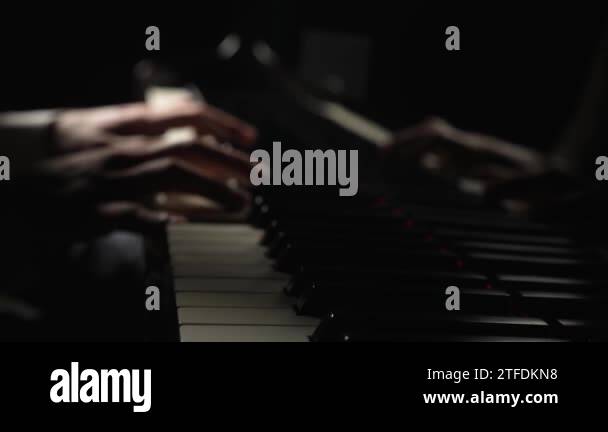 Talented pianist plays classical melody on piano in dark. Blurred shot ...