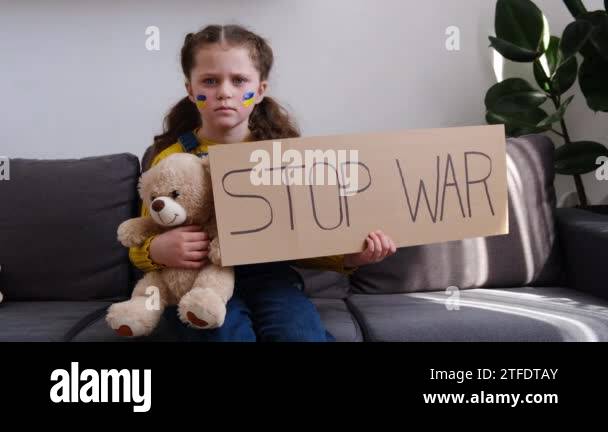 Ukrainian little girl kid protesting war conflict holding banner with ...