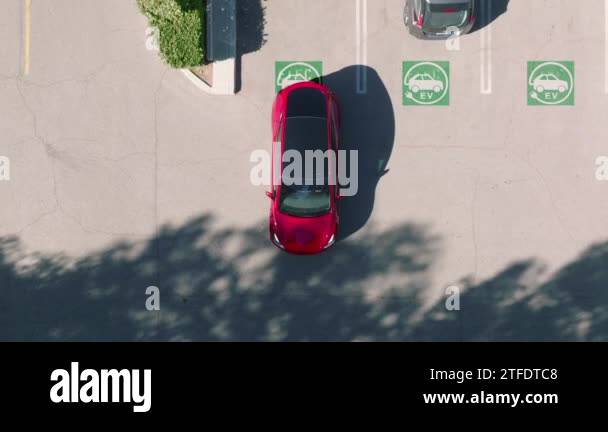 Aerial view of car parking under solar panels, 4K electric zero ...